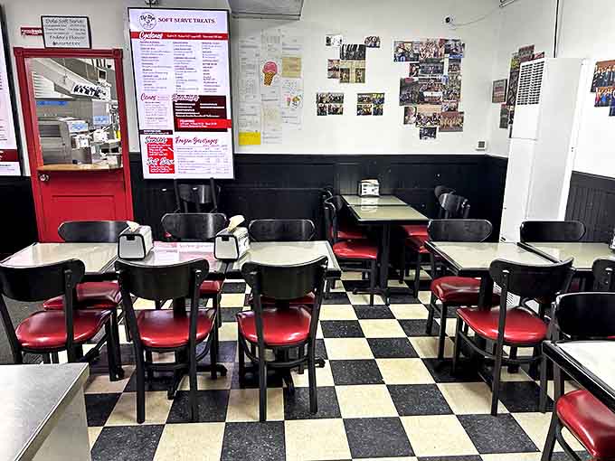 Classic black and white checkered floors meet cherry-red seats in this time capsule of American dining nostalgia.