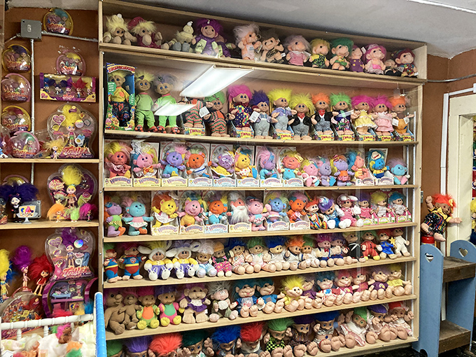 Wall-to-wall nostalgia hits you like a rainbow hurricane as thousands of troll dolls with their iconic wild hair create a dizzying display of collectible history.