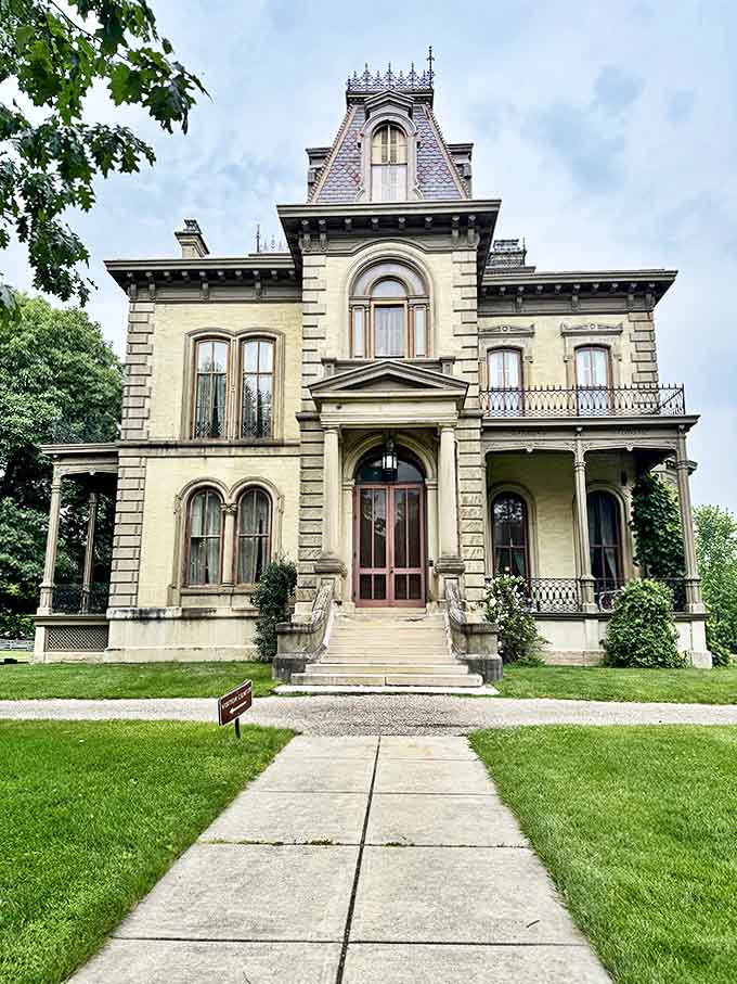 The mansion's stately front fa&ccedil;ade welcomes visitors with its grand entrance, ornate details, and perfect symmetry &ndash; Victorian curb appeal at its finest!