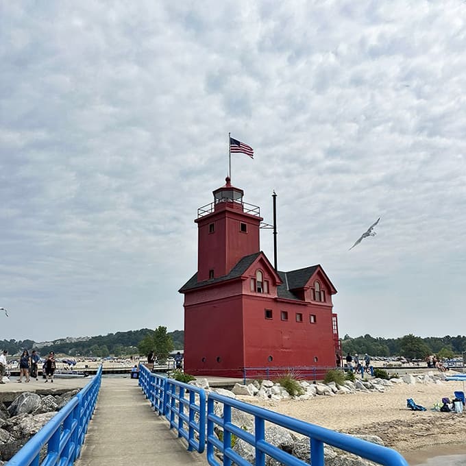 The blue-railed walkway stretches toward Big Red like a path to maritime history, inviting visitors to experience the lighthouse up close and personal.