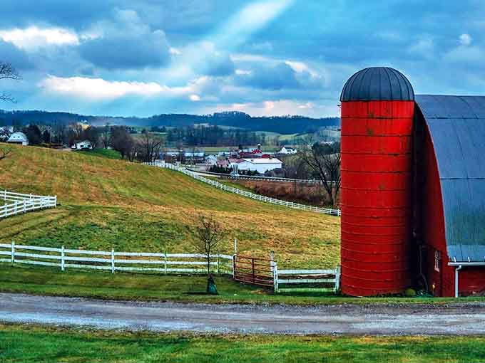 That classic red silo stands like a sentinel over the farmland, a bold exclamation point on nature's perfect paragraph of pastoral beauty.