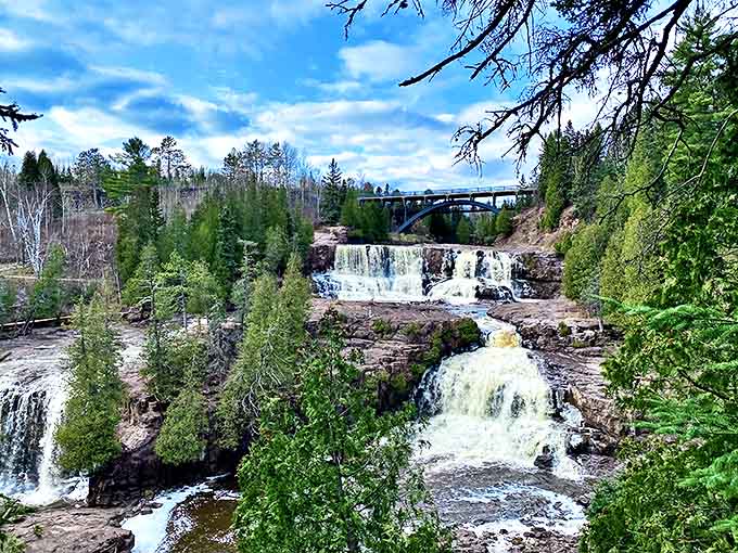 The waterfall's powerful flow creates a misty spectacle as it tumbles over billion-year-old rock formations, nature's own percussion section playing a timeless tune.