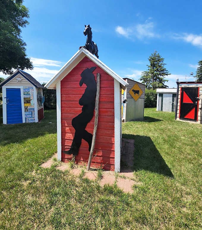This red outhouse with its unicorn silhouette proves that even mythical creatures need a special place for private moments.