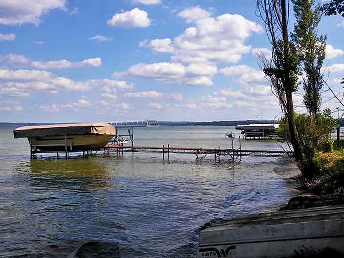 Simple pleasures: A wooden dock stretches toward Hubbard Lake's horizon, inviting bare feet and quiet contemplation away from life's chaos.