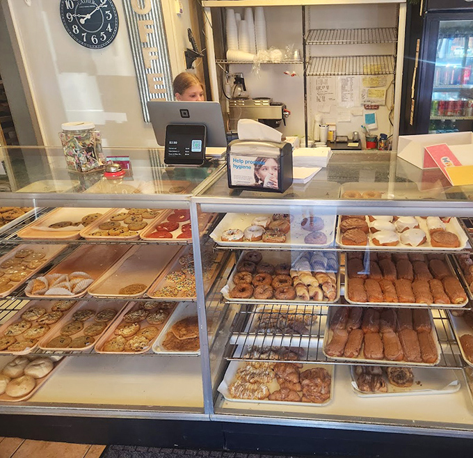 Behind the spotless glass, a treasure trove of donuts awaits &ndash; each one hand-crafted and glistening with that perfect glaze.