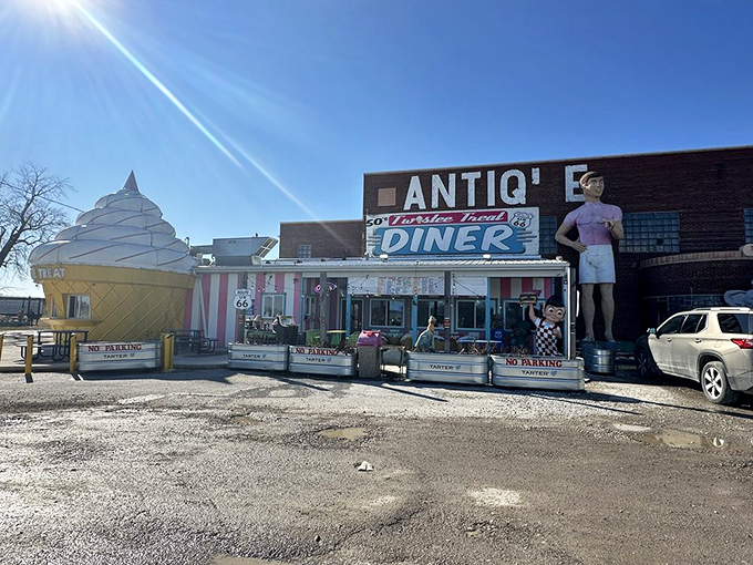 Roadside Americana at its finest – where else can you find a pink-striped diner, giant ice cream cone, and muffler man all in one photo?