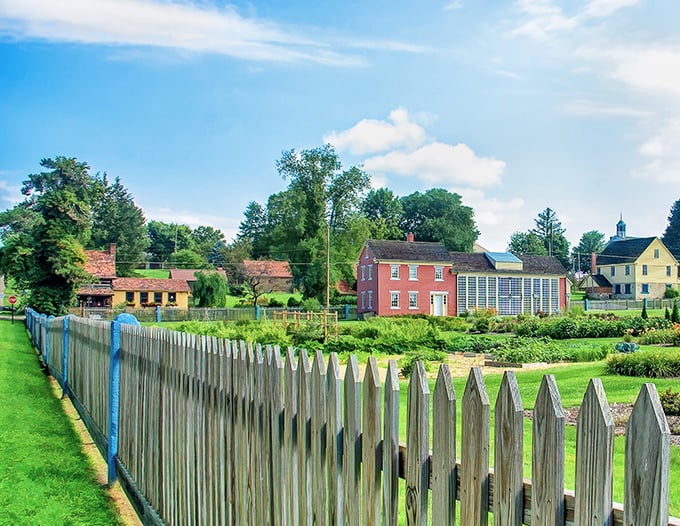 Picket fences frame meticulously preserved homes where time seems to have paused two centuries ago.