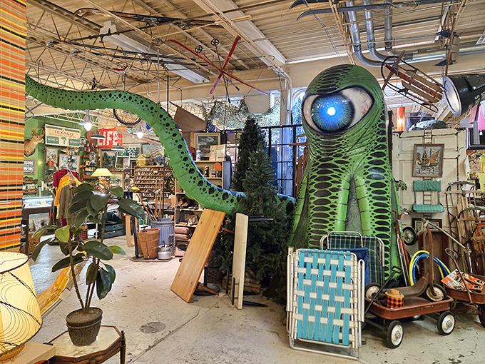 Step inside and meet your new friend – a towering green alien with a hypnotic blue eye surveying his domain of mid-century treasures.