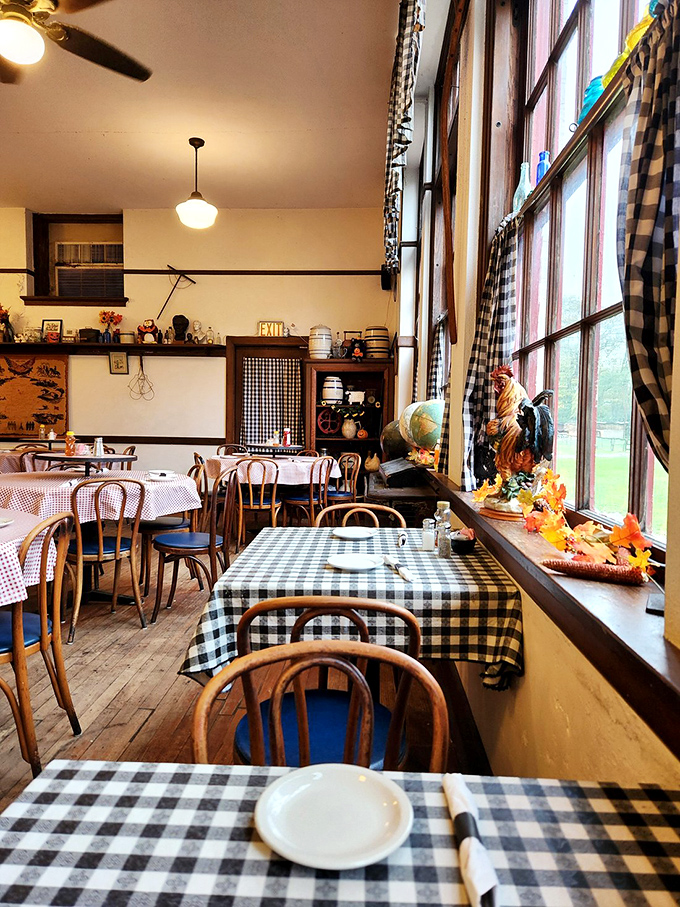 Checkered tablecloths and wooden chairs create an atmosphere where comfort meets nostalgia in this former classroom turned dining haven.