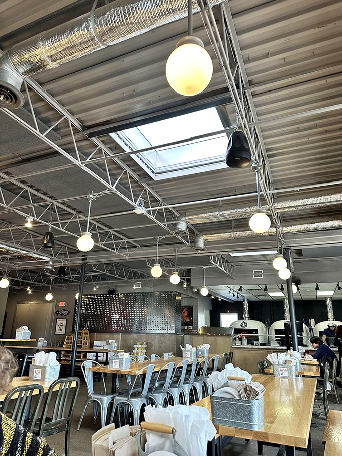 Industrial-chic meets cozy comfort in this airy space where pizza dreams come true and strangers become friends over shared tables.
