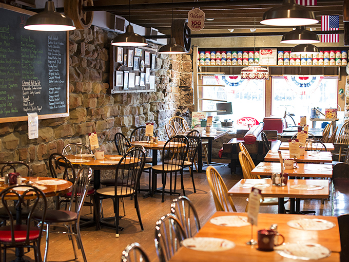 Stone walls and wooden beams create a rustic time capsule where conversations flow as smoothly as the hot fudge on your sundae.