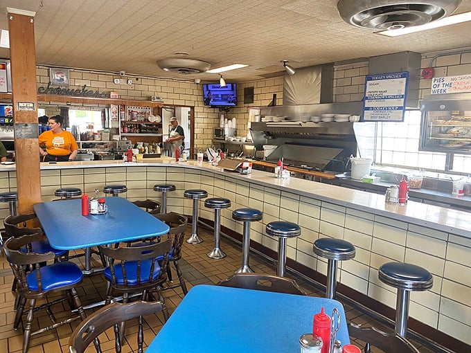 Interior: Blue formica tables and vintage counter stools create a time capsule where calories don't count and conversations flow as freely as the coffee.