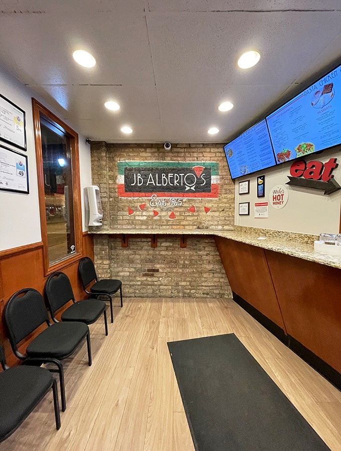Simple, no-nonsense interior where pizza magic happens &ndash; exposed brick walls tell stories of decades serving the Rogers Park neighborhood.