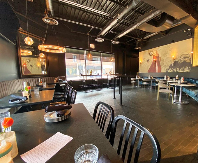 Moody lighting, artistic murals, and comfortable seating create the perfect backdrop for serious burger enjoyment.