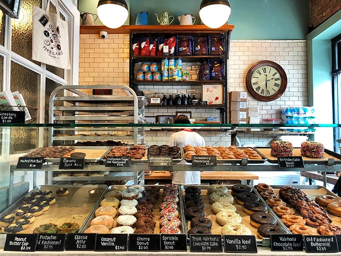 A donut lover's paradise awaits inside, with rows of handcrafted creations displayed like edible jewels behind spotless glass.