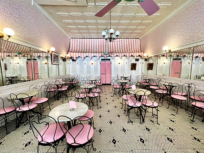 Step into a bygone era where pink-cushioned ice cream chairs, striped awnings, and gleaming mirrors create the perfect backdrop for memory-making.
