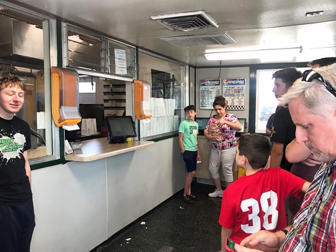 Inside Val's, the efficient counter service keeps the line moving as families eagerly await their turn at burger bliss.