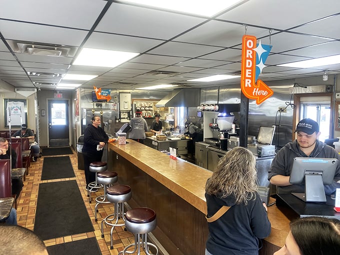 Counter culture at its finest &ndash; where friendly faces, sizzling grills, and that iconic "ORDER HERE" sign create the perfect diner symphony.