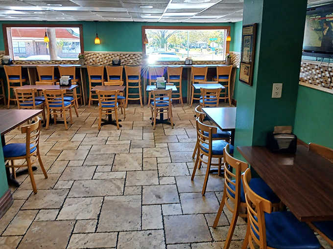 Teal walls and warm wood create a welcoming space that feels more neighborhood gathering spot than corporate bakery, exactly as it should be.