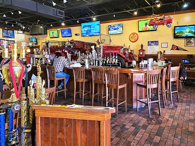 The bar area features a genuine antique fire engine, where spirits flow freely beneath the watchful gaze of firefighting history.