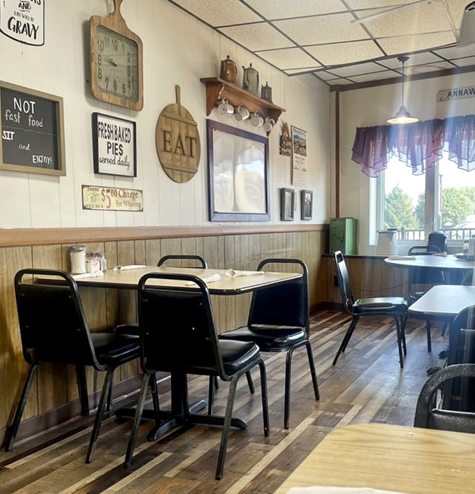 Step inside to find a dining room that feels like a warm hug &ndash; wood paneling, vintage signs, and that "EAT" cutting board saying what we're all thinking.