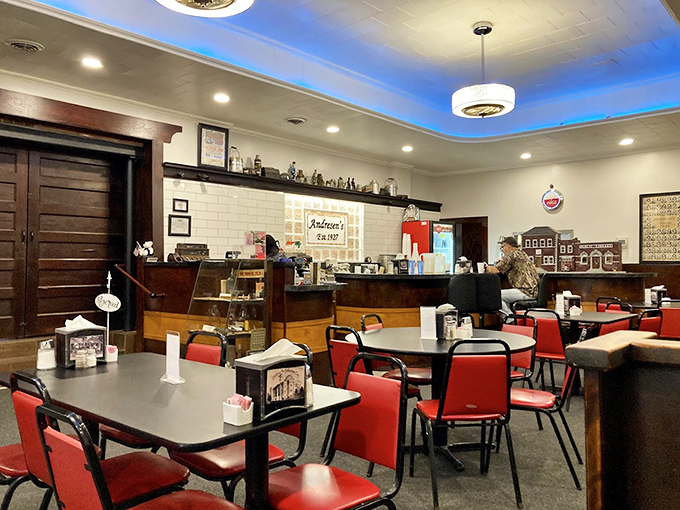 Red vinyl chairs and warm wood tones create that perfect diner atmosphere where conversations flow as freely as the coffee.