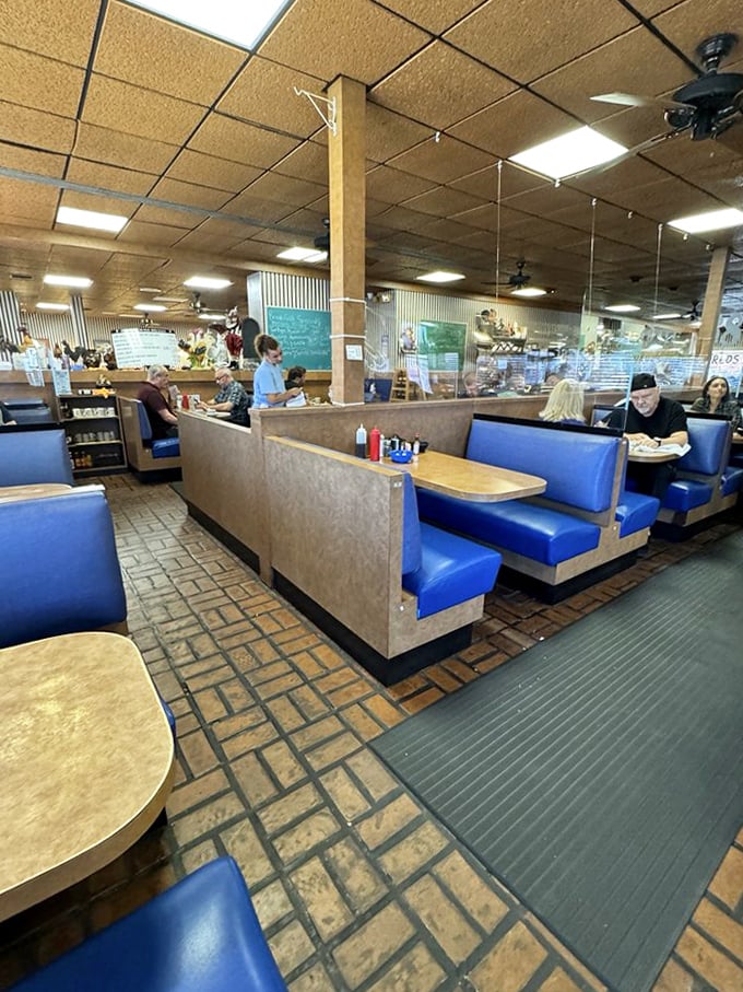 Classic blue vinyl booths and brick-patterned floors create that perfect "been here forever" vibe where comfort trumps trendiness every time.