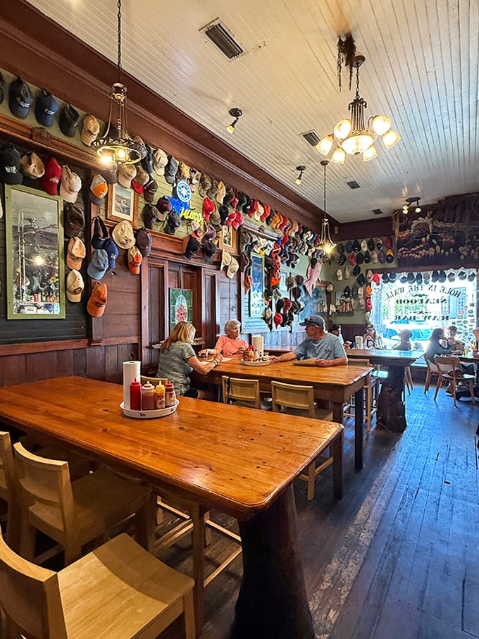 Baseball caps from loyal patrons create a colorful tapestry across the ceiling and walls &ndash; each one a story, collectively forming the restaurant's unique personality.