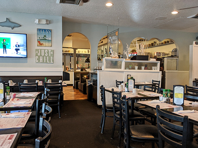 Cozy interior blending coastal casual with thoughtful design &ndash; where exposed brick meets woven pendant lights and comfortable seating invites lingering conversations.