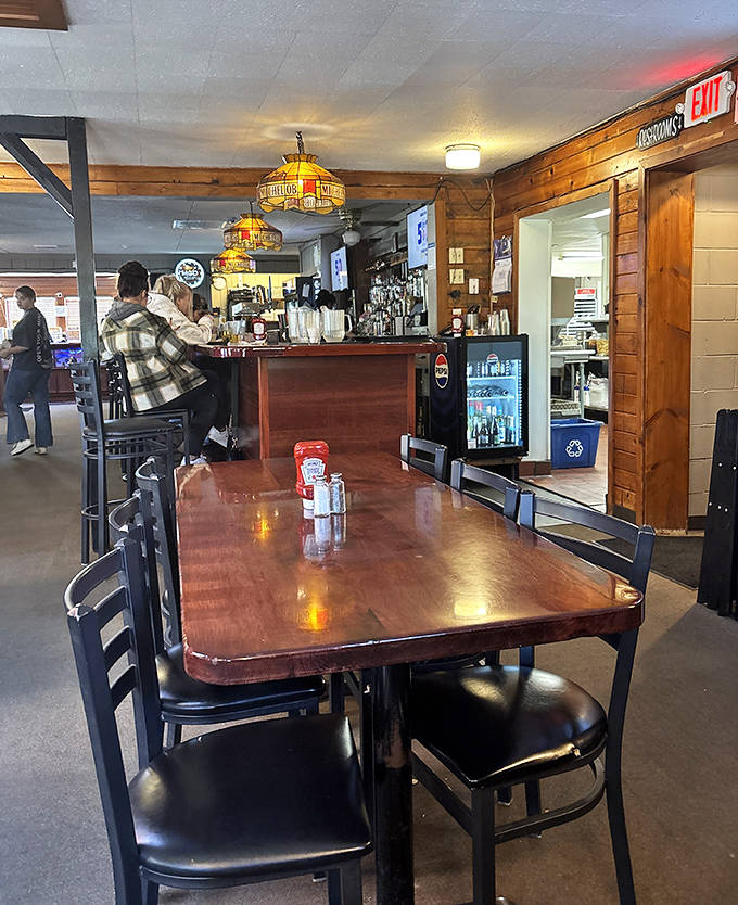 Warm wood paneling and vintage lighting create that "everybody knows your name" vibe that makes first-timers feel like regulars.