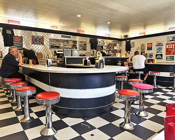 Chrome, vinyl, and checkered floors create a time machine that runs on burgers and milkshakes instead of plutonium.
