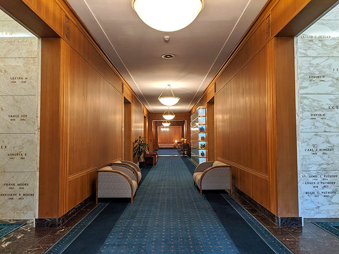 Warm wood paneling and elegant marble create a hallway that feels more like a luxury hotel than a cemetery building.