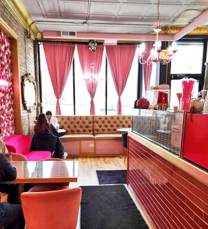 Step inside to discover a pink paradise where exposed brick meets velvet seating, creating the perfect backdrop for memorable brunches.