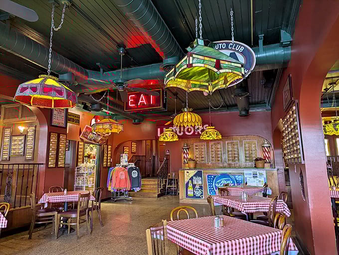 Stained-glass splendor: The warm interior features vintage lamps hanging above red-checkered tables, creating an atmosphere of nostalgic comfort.