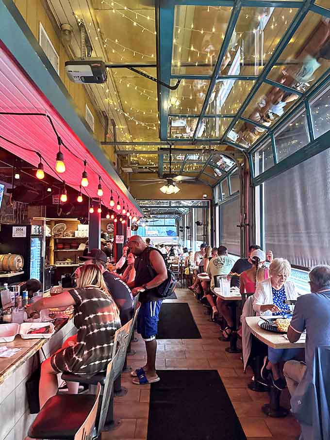 String lights twinkle overhead as diners enjoy their meals along the platform, creating a magical atmosphere where railway history meets modern gastronomy.