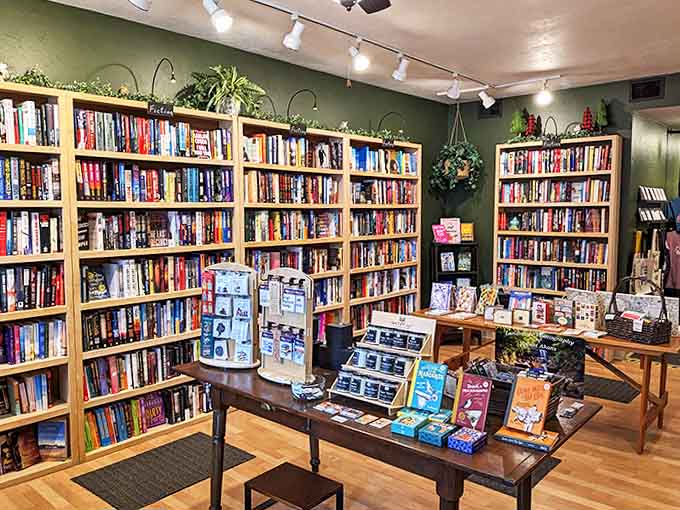 Emerald walls create the perfect backdrop for wooden shelves bursting with literary treasures, a forest of stories waiting to be explored.