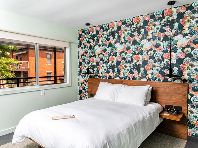 Floral wallpaper meets modern bedding in this stylish room where vintage aesthetics don't compromise on comfort.
