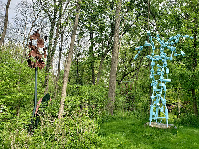 Towering steel creations rise from the grass like mechanical flowers blooming in an industrial garden that somehow feels perfectly natural.