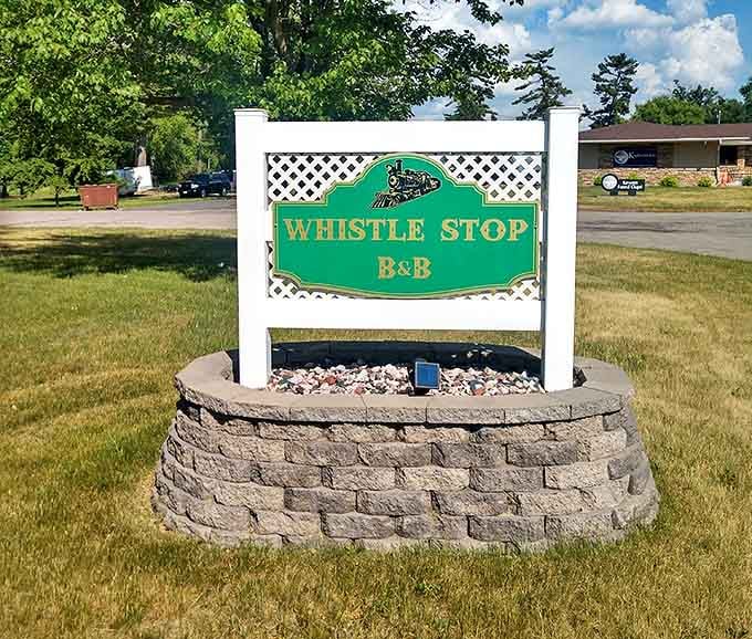 The Whistle Stop B&B sign stands as a beacon for weary travelers, promising vintage charm with modern comforts just beyond.