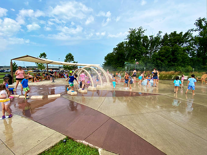 Summer's perfect playground – children dash through arching water tunnels while colorful sprays create a cooling oasis on hot Ohio days.