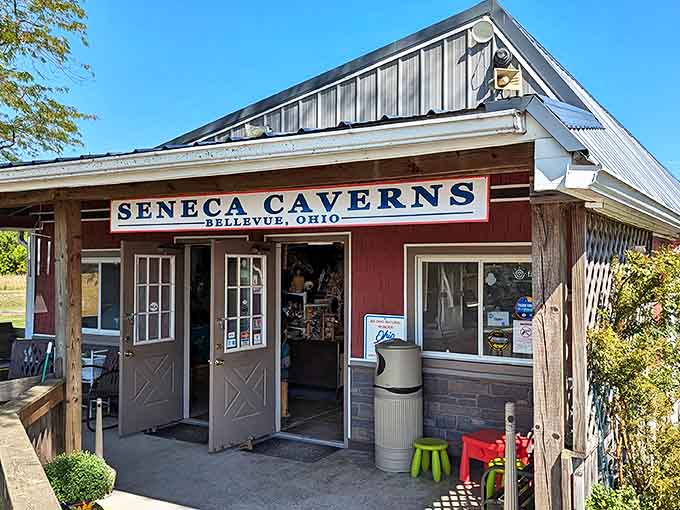 The charming red visitor center welcomes cave enthusiasts with Midwestern warmth and the promise of subterranean wonders just steps away.