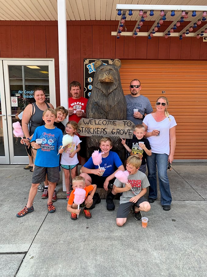 A carved wooden bear welcomes visitors to Stricker's Grove, standing guard like a friendly sentinel from a bygone era of family entertainment.