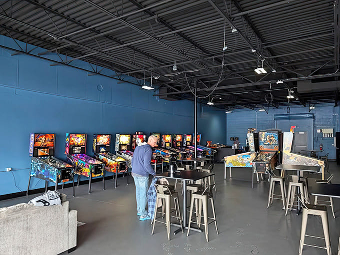 Blue walls create the perfect backdrop for this gaming paradise, where every machine waits patiently for its next challenger.