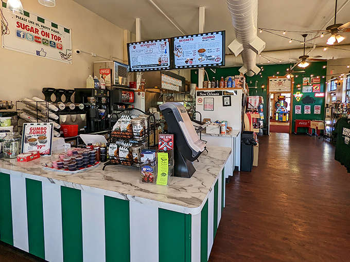Inside, the marble counter and striped decor create that perfect casual vibe where powdered sugar mishaps are not just allowed, but expected.