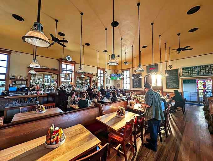 Church pews repurposed as dining seating? Genius! The stained glass windows cast a glow that makes everyone look like they've been touched by culinary grace.