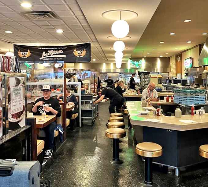Inside Lou Mitchell's, the bustling diner atmosphere hums with conversation while servers navigate the floor with practiced precision.