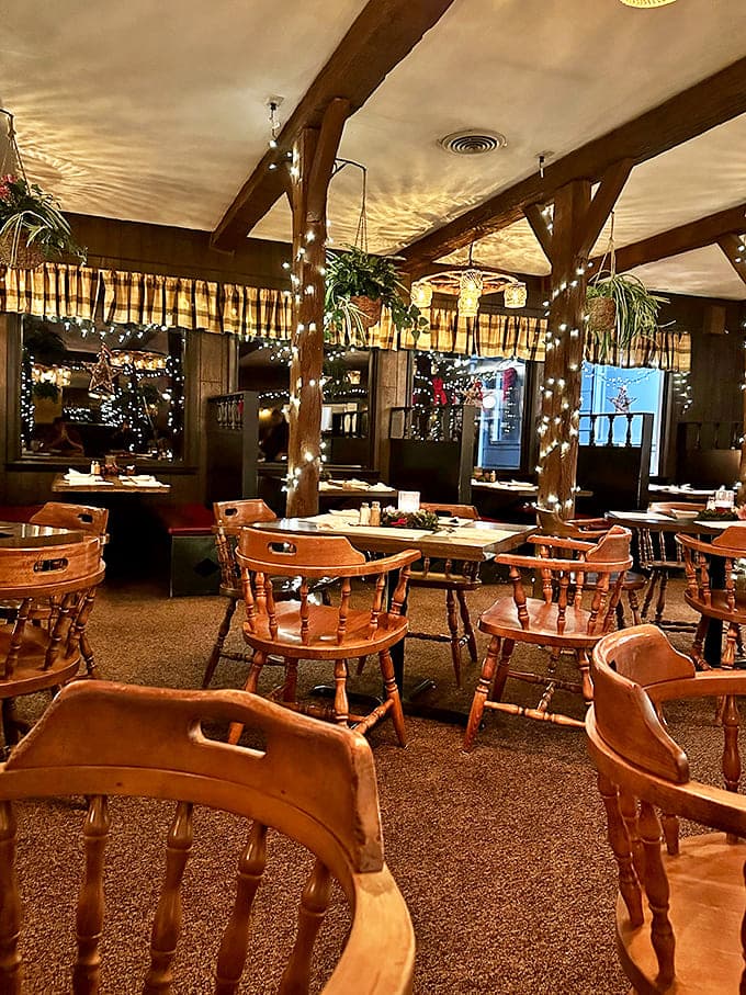 Wooden beams adorned with twinkling lights create a magical dining atmosphere that's both rustic and elegant.