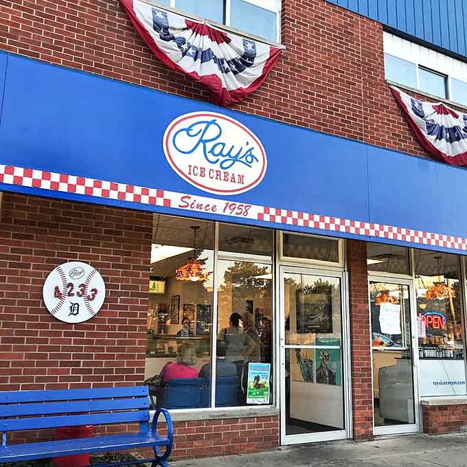 Ray's Ice Cream's classic brick storefront with its patriotic bunting celebrates over 60 years of scooping happiness in Royal Oak. The checkerboard trim hints at the nostalgic experience waiting inside.