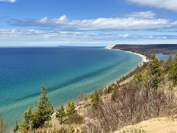 The sweeping coastline of Sleeping Bear Dunes offers a breathtaking panorama where turquoise waters meet dramatic sand cliffs.