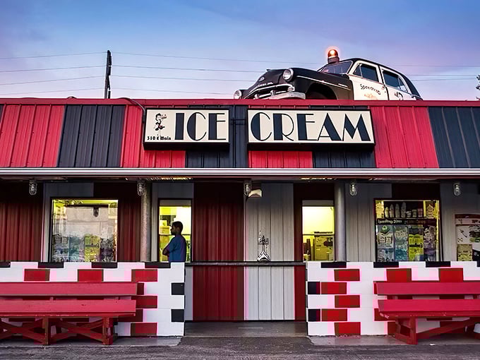 The Speedtrap Diner's vibrant red exterior with a vintage police car on top makes for an irresistible roadside photo op.